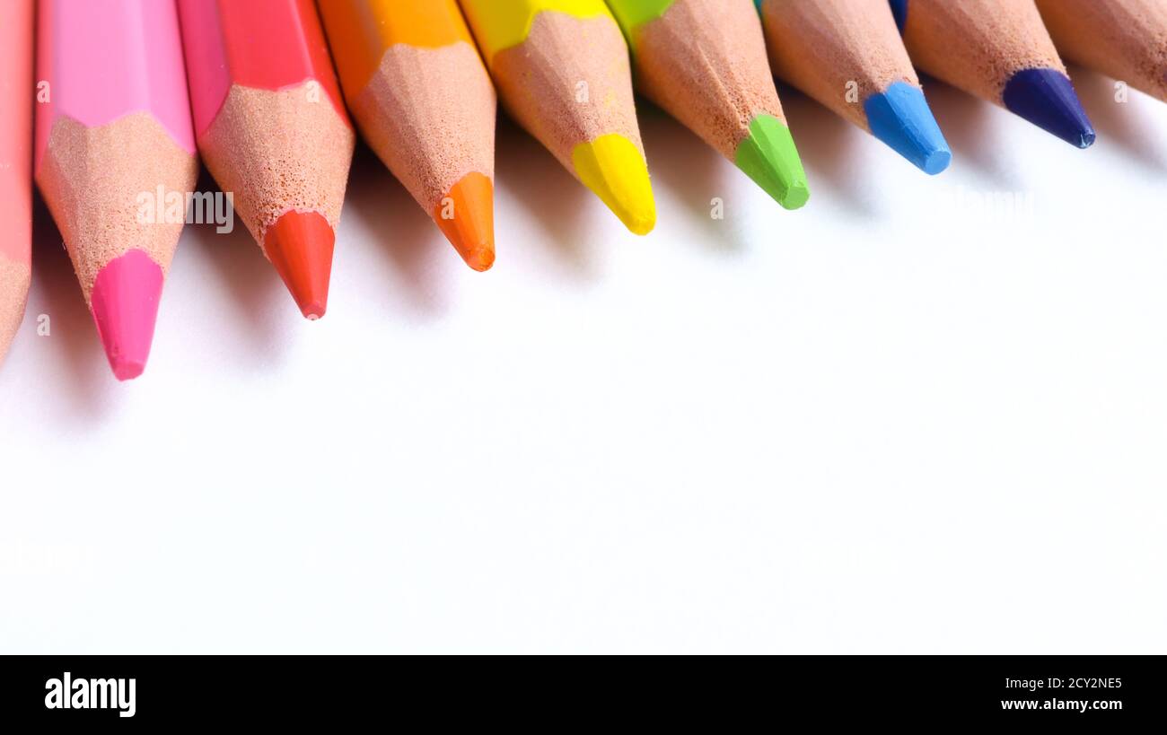 Red, orange, yellow, green, blue, pink color pencils close-up isolated ...