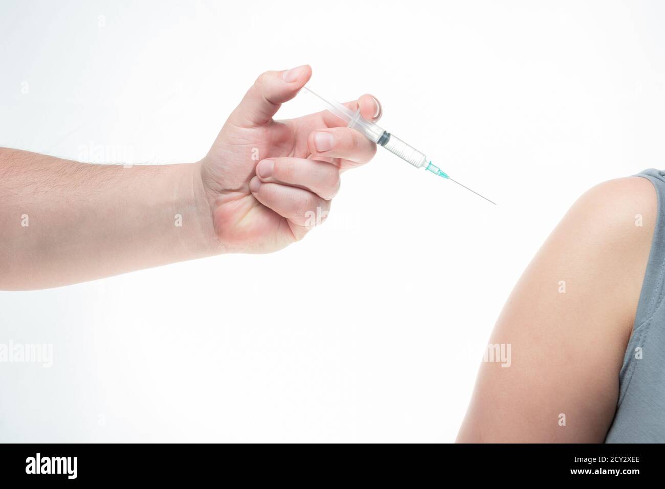 Doctor's hand giving an injection to a patient isolated on a white ...