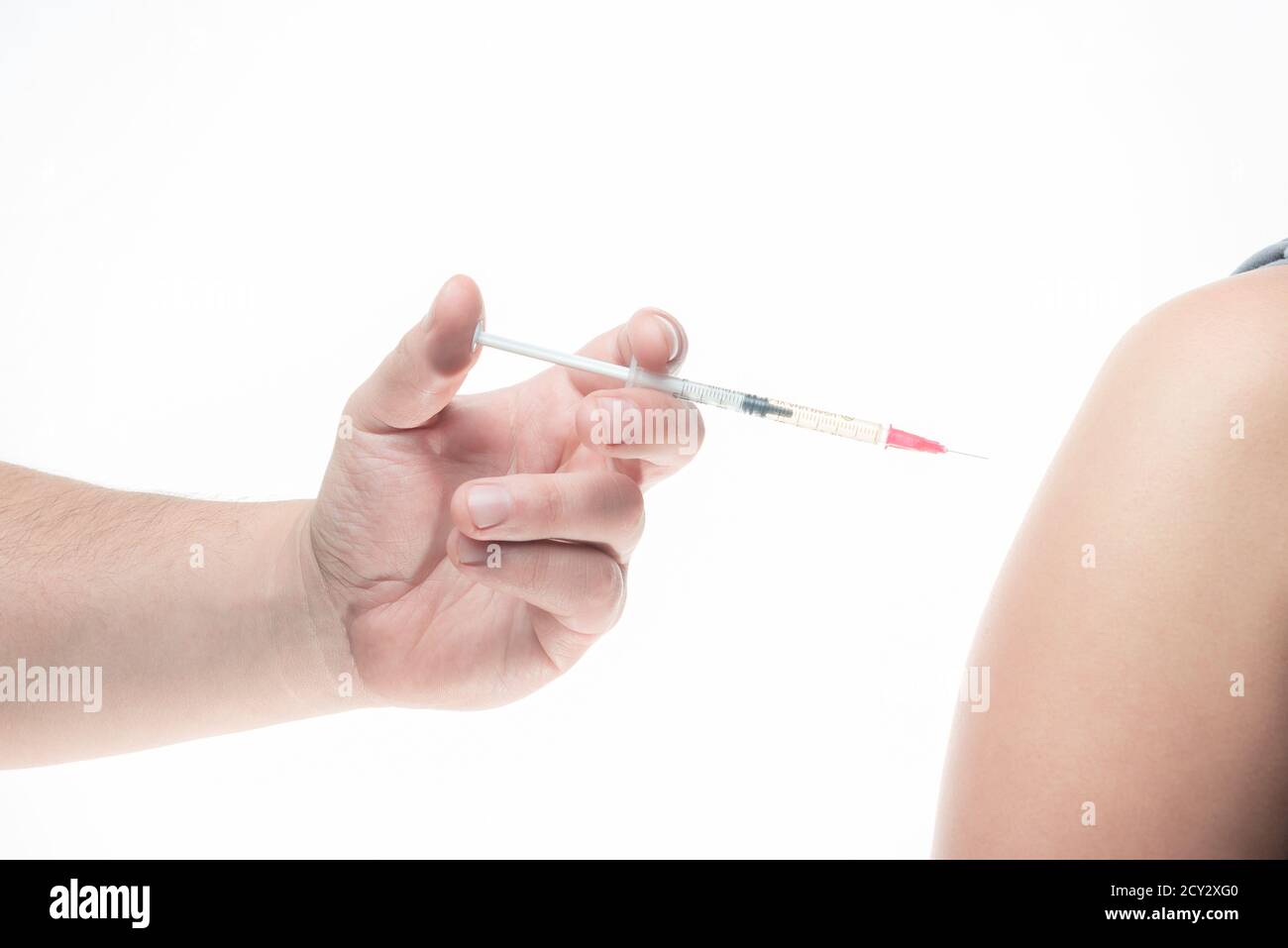 Doctor's hand giving an injection to a patient isolated on a white ...
