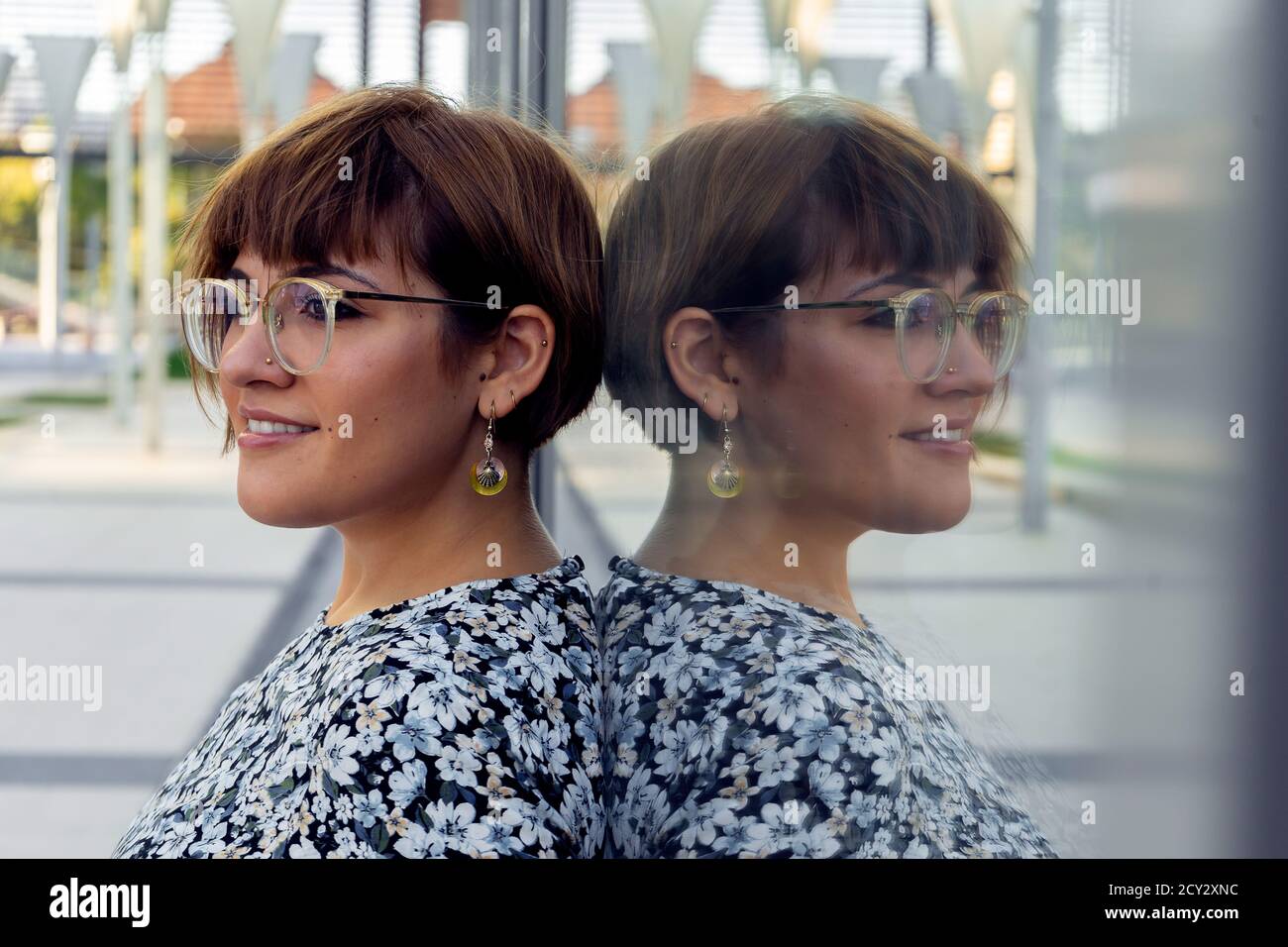 Portrait of a woman. Reflection in glass. Mirror effect Stock Photo - Alamy