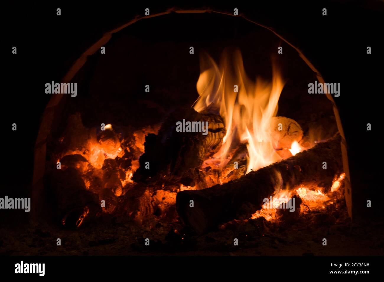 Russian stove. Red orange yellow burning wood. Traditional furnace with ...