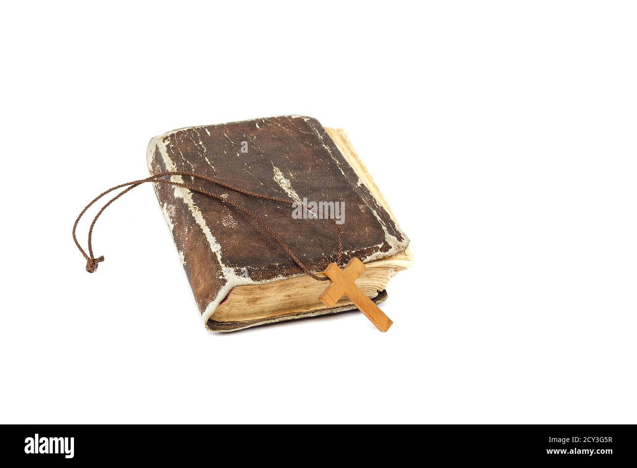 Ancient holy book of a wooden cross on a cord isolated on a white ...