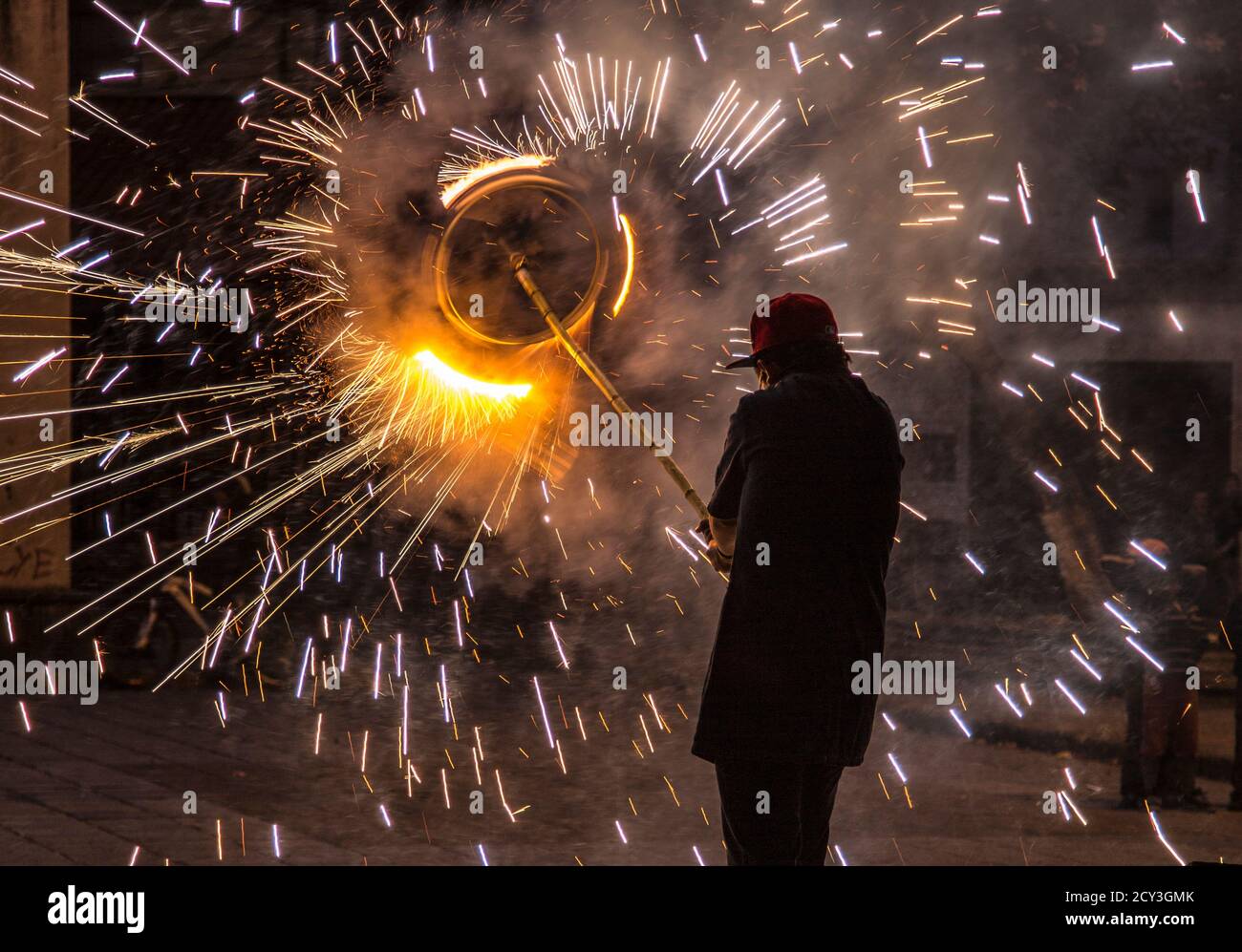 Cuenca, Ecuador - Nov 29, 2012: Man holds fireworks pinwheel at the end ...