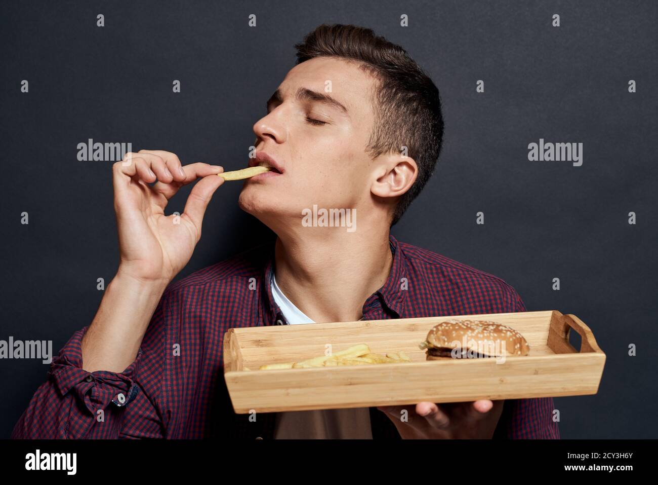 man holding wooden pallet with fast food in his hands diet food hunger ...