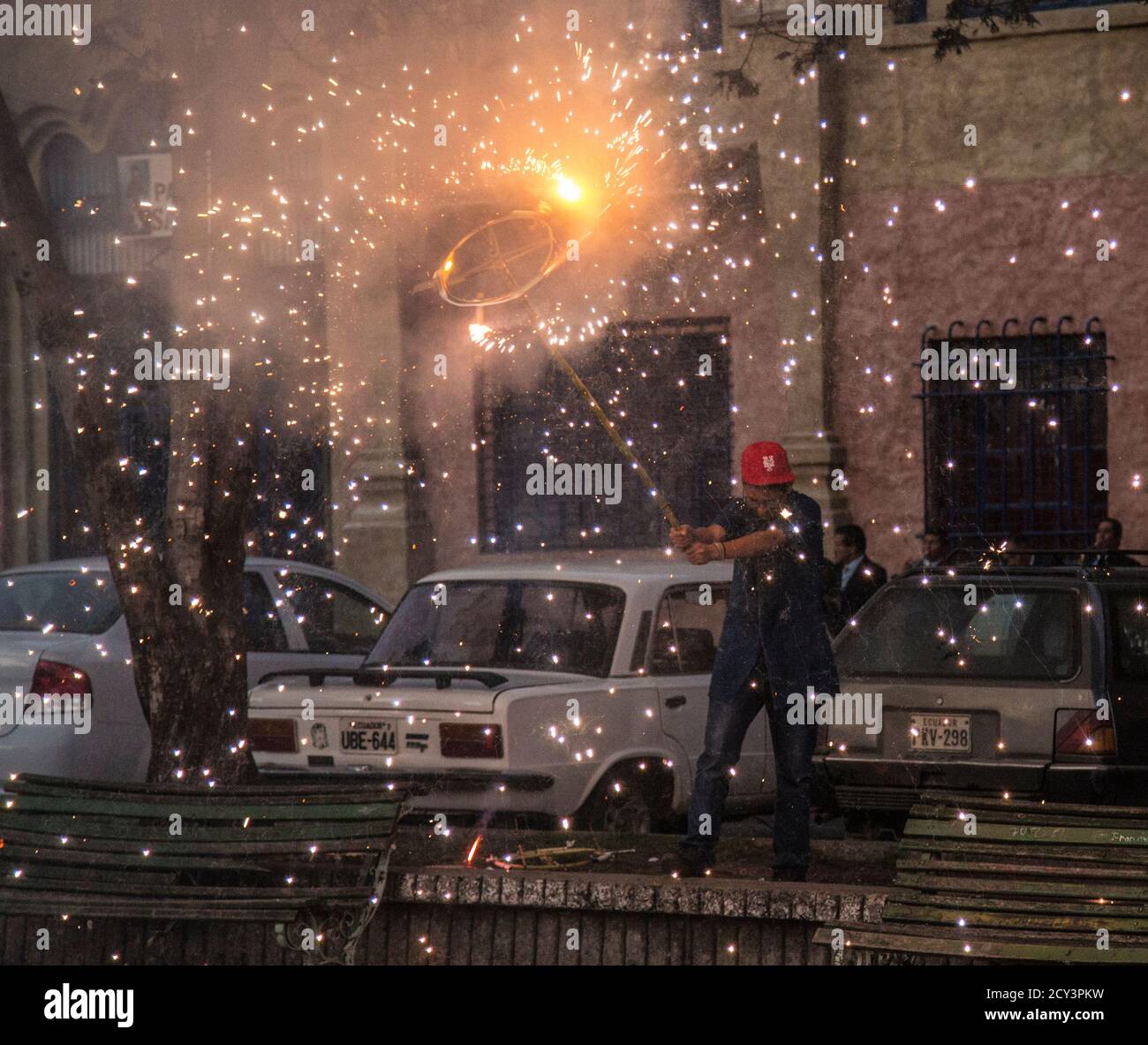 Cuenca, Ecuador - Nov 29, 2012: Man holds fireworks pinwheel at the end ...