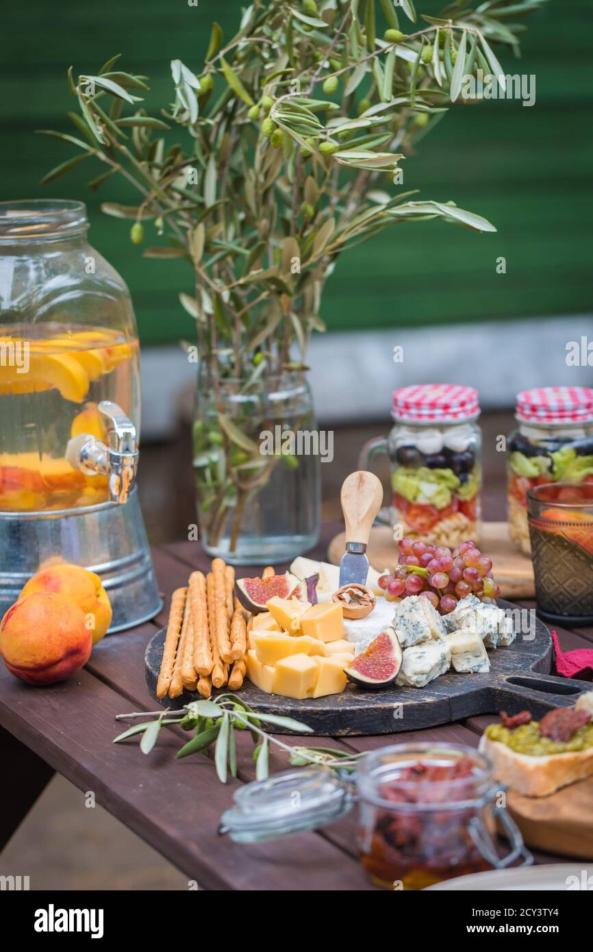 Assorted Italian food table setting in the garden, delicious snack on ...