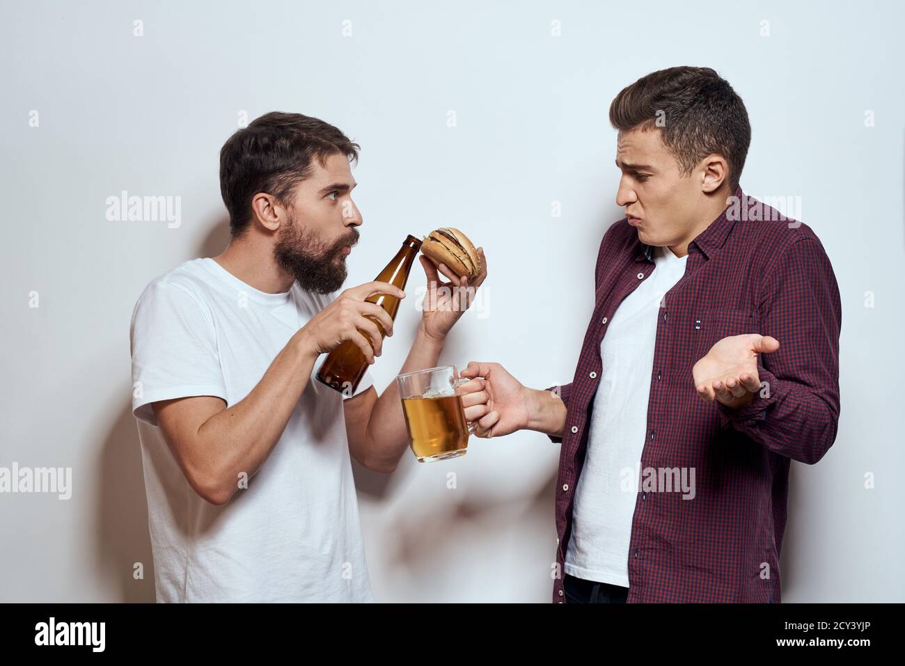Two cheerful friends drinking beer drunk fun lifestyle communication ...