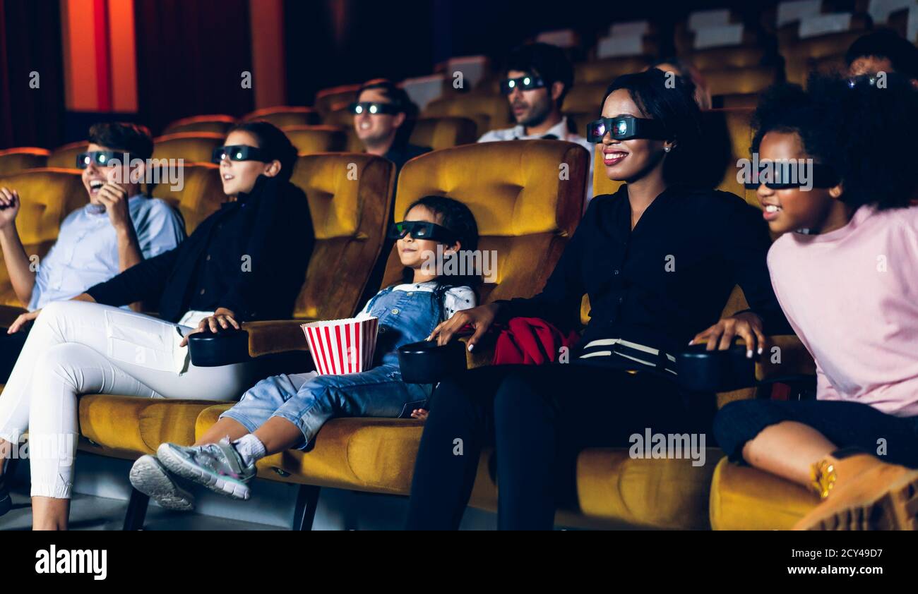 Group of people watch movie with 3D glasses in cinema theater with ...