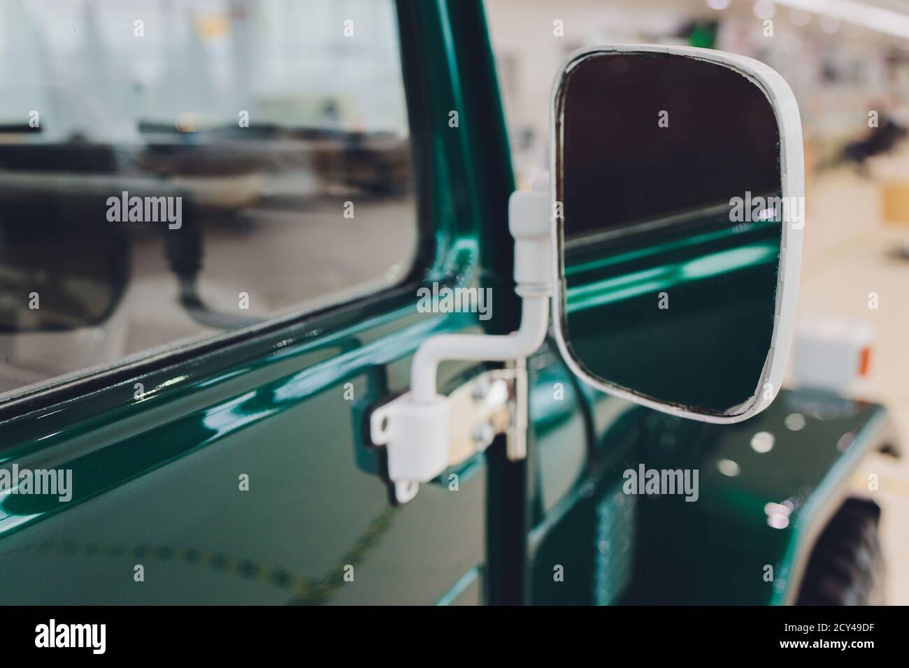 green dirty car in dust side view on the door and mirror on a sunny day ...