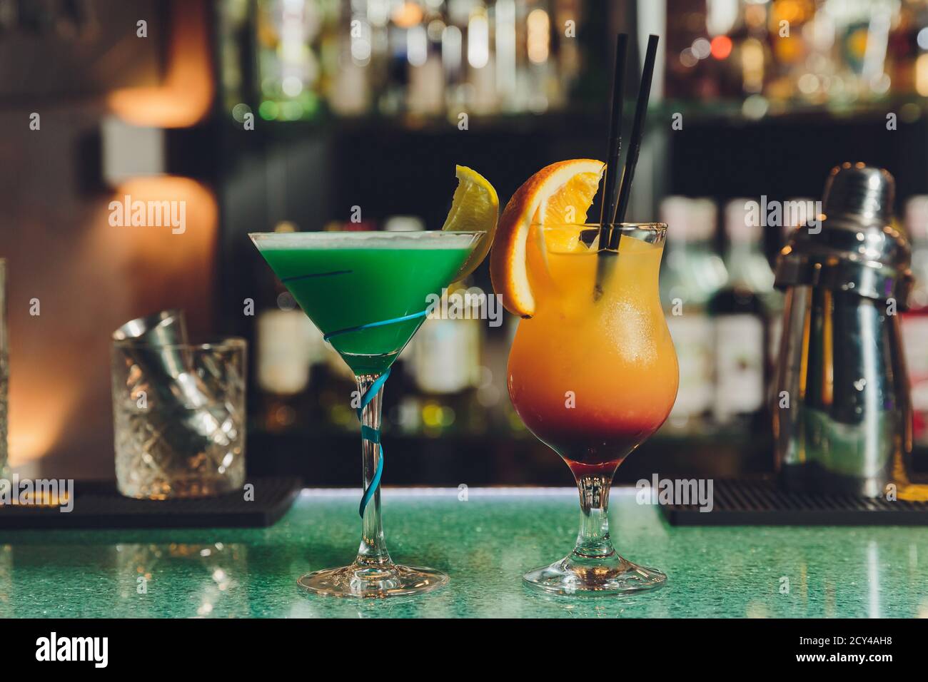 Green cocktail in modern glass on bar background Stock Photo - Alamy