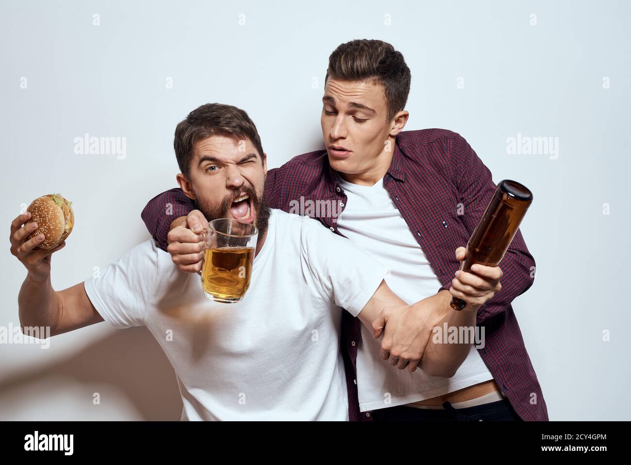 Two cheerful friends drinking beer drunk fun lifestyle communication ...