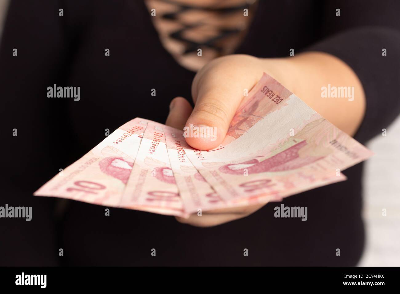 Hand offering money Stock Photo - Alamy