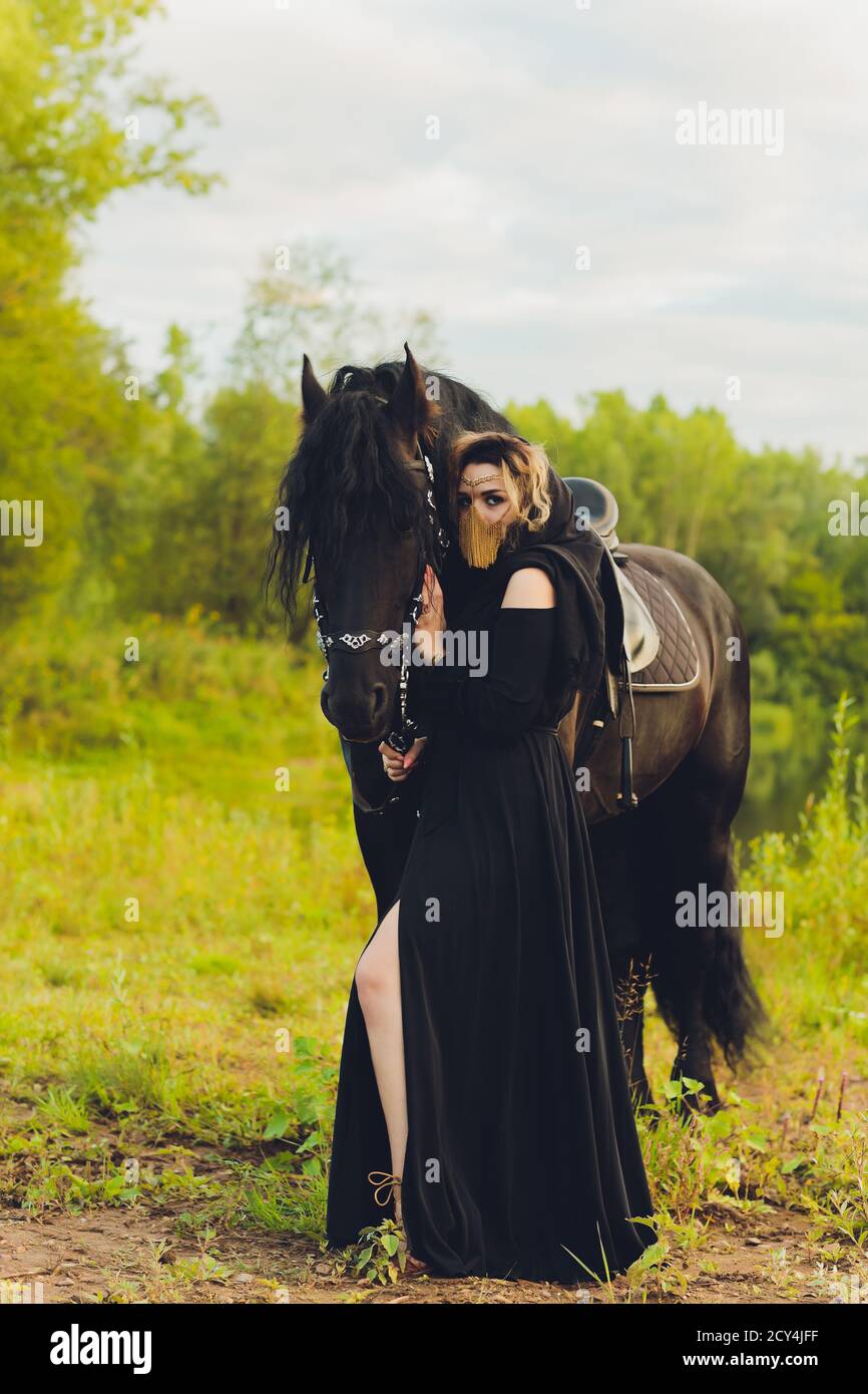 Muslim woman in hijab riding a horse Stock Photo - Alamy