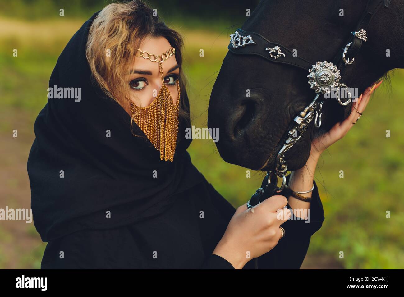 Muslim woman in hijab riding a horse Stock Photo - Alamy