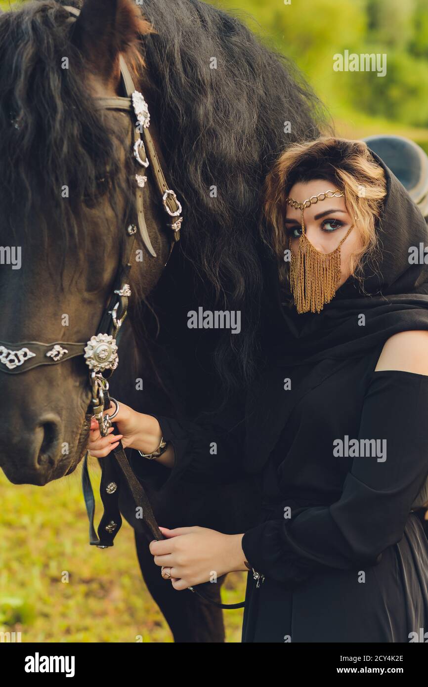 Muslim woman in hijab riding a horse Stock Photo - Alamy