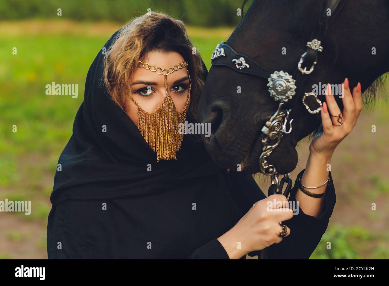 Muslim woman in hijab riding a horse Stock Photo - Alamy