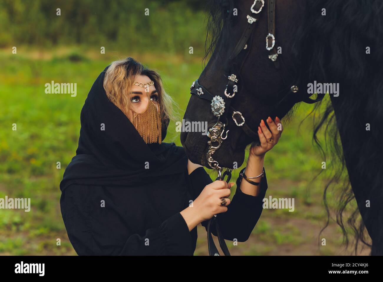 Muslim woman in hijab riding a horse Stock Photo - Alamy