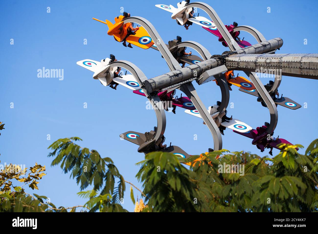 Riding on an attraction in the form of an airplane. Amusement Park in ...