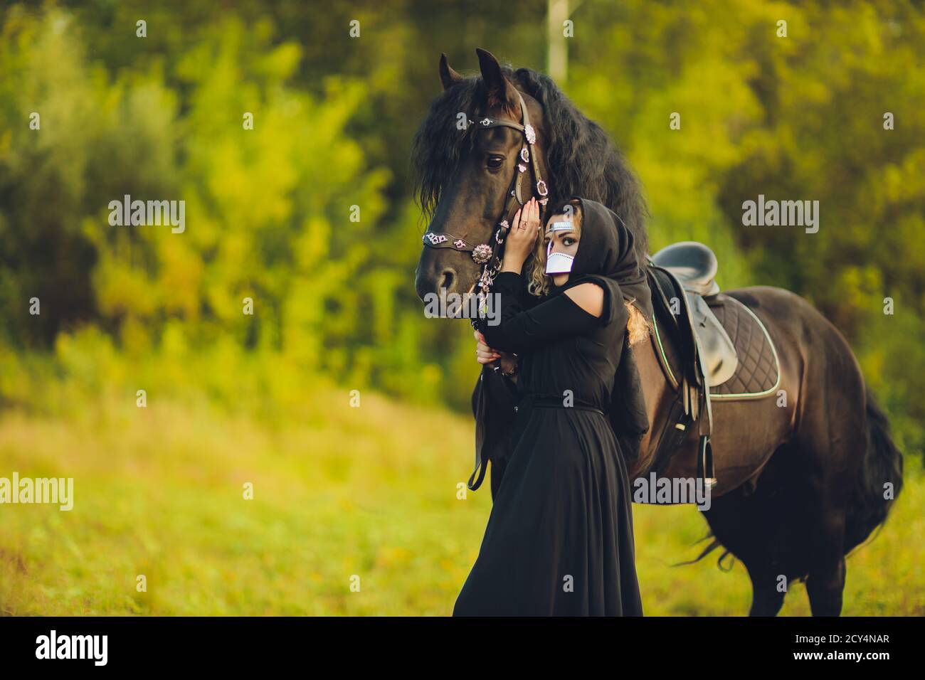 Muslim woman in hijab riding a horse Stock Photo - Alamy