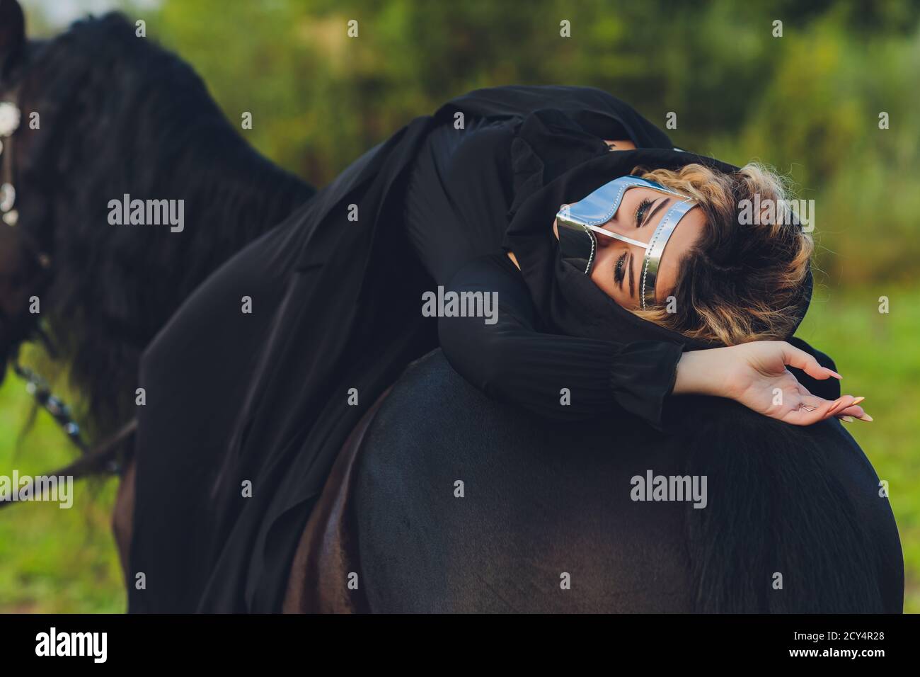 Muslim woman in hijab riding a horse Stock Photo - Alamy