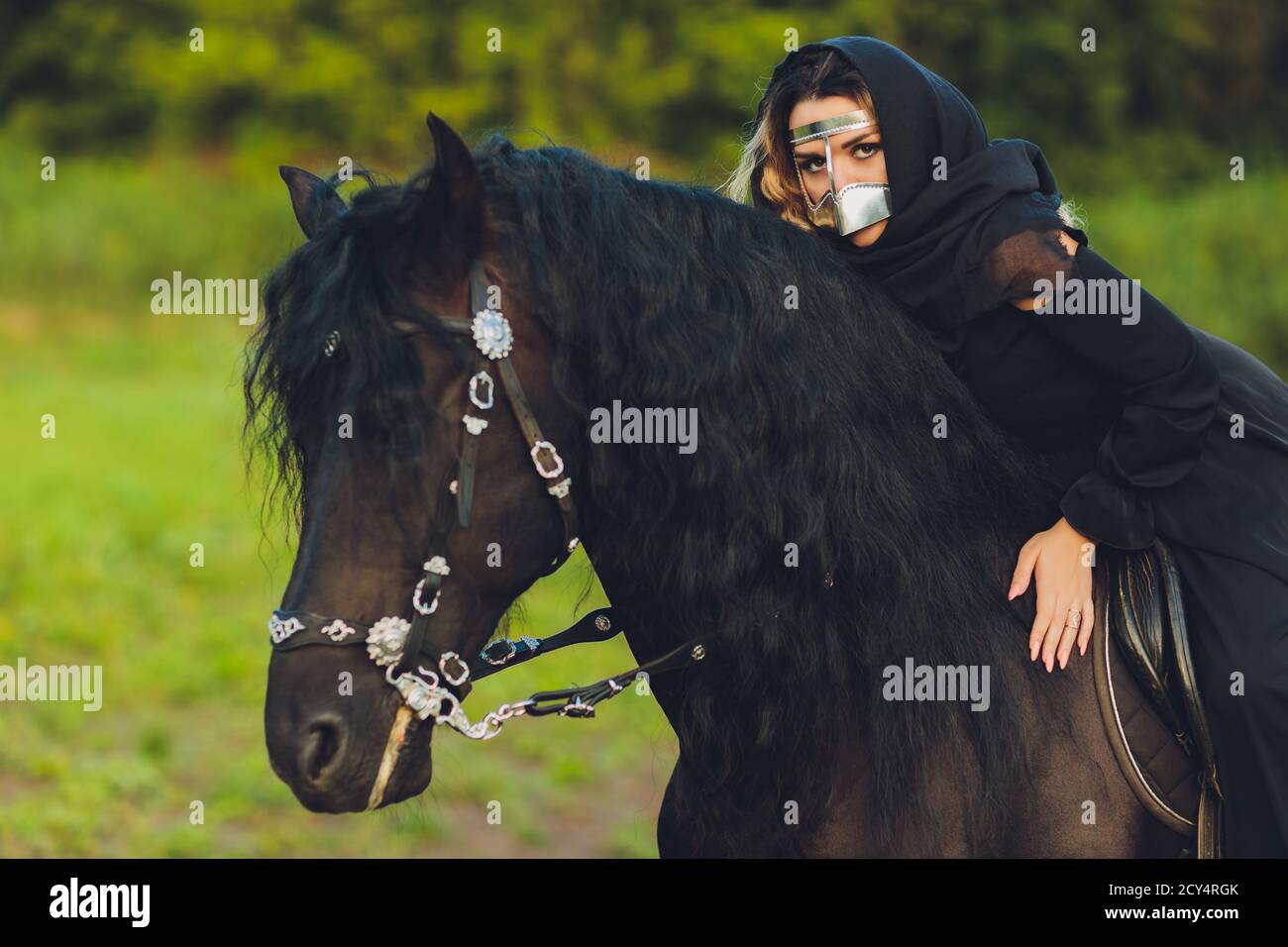 Muslim woman in hijab riding a horse Stock Photo - Alamy