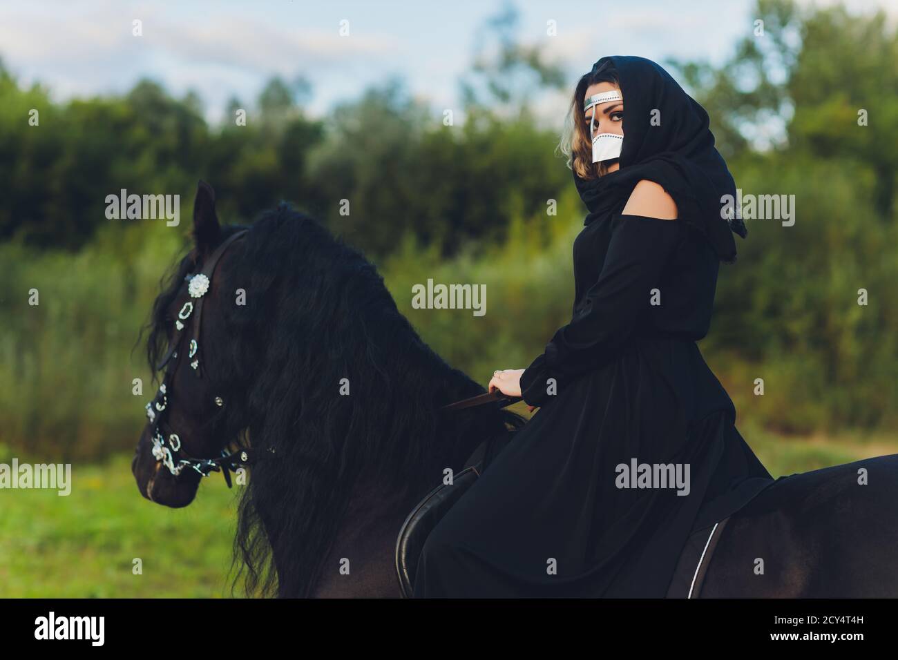 Muslim woman in hijab riding a horse Stock Photo - Alamy