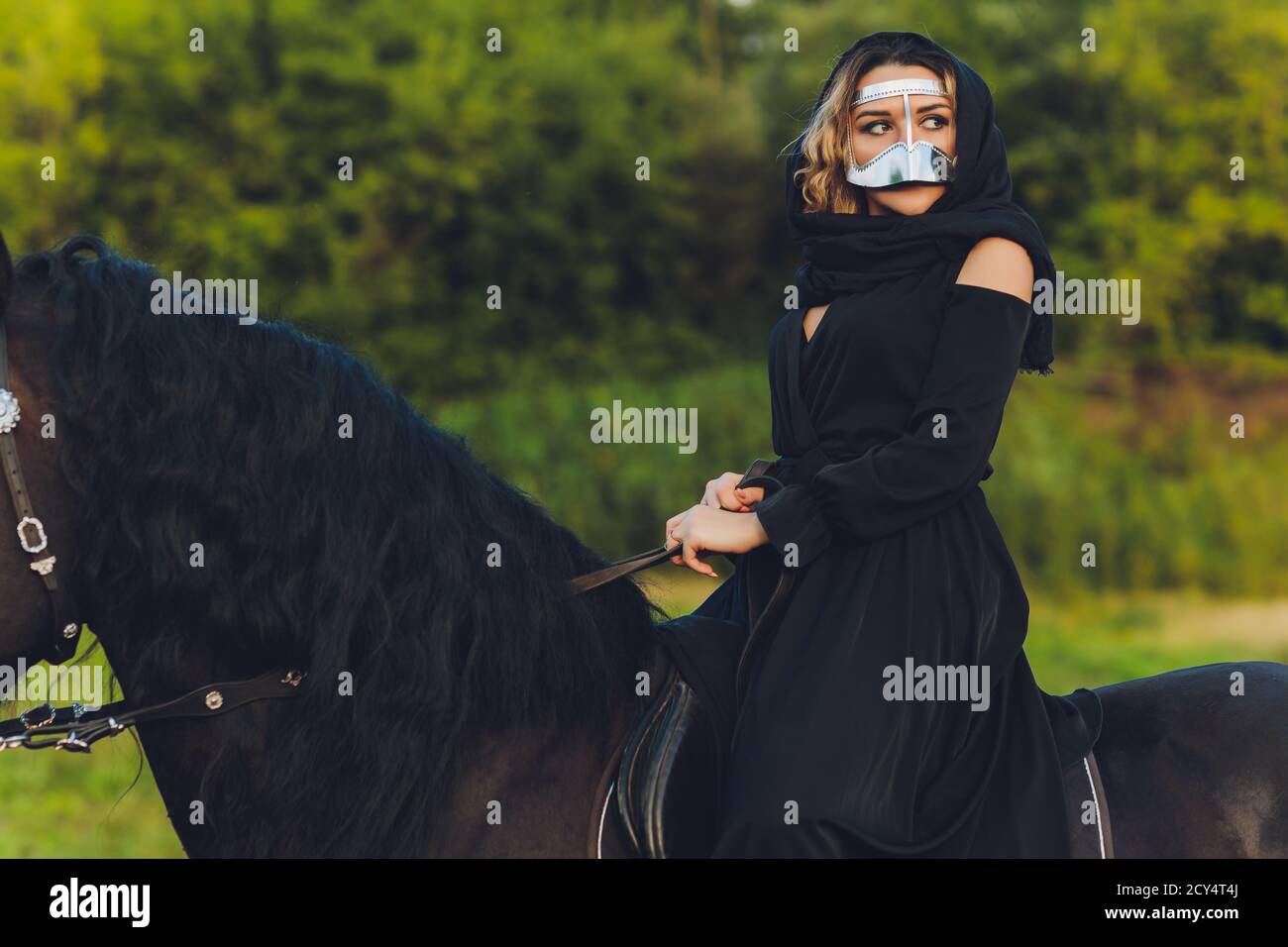 Muslim woman in hijab riding a horse Stock Photo - Alamy