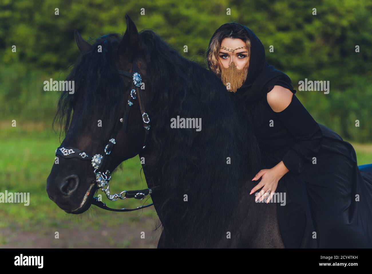 Muslim woman in hijab riding a horse Stock Photo - Alamy