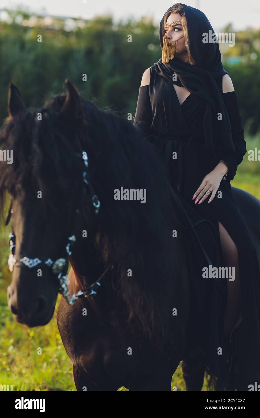 Muslim woman in hijab riding a horse Stock Photo - Alamy