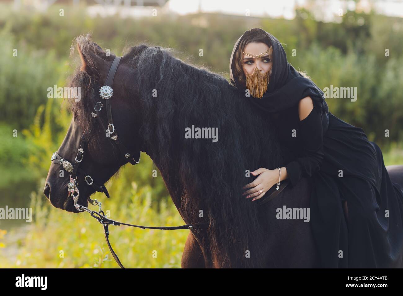 Muslim woman in hijab riding a horse Stock Photo - Alamy