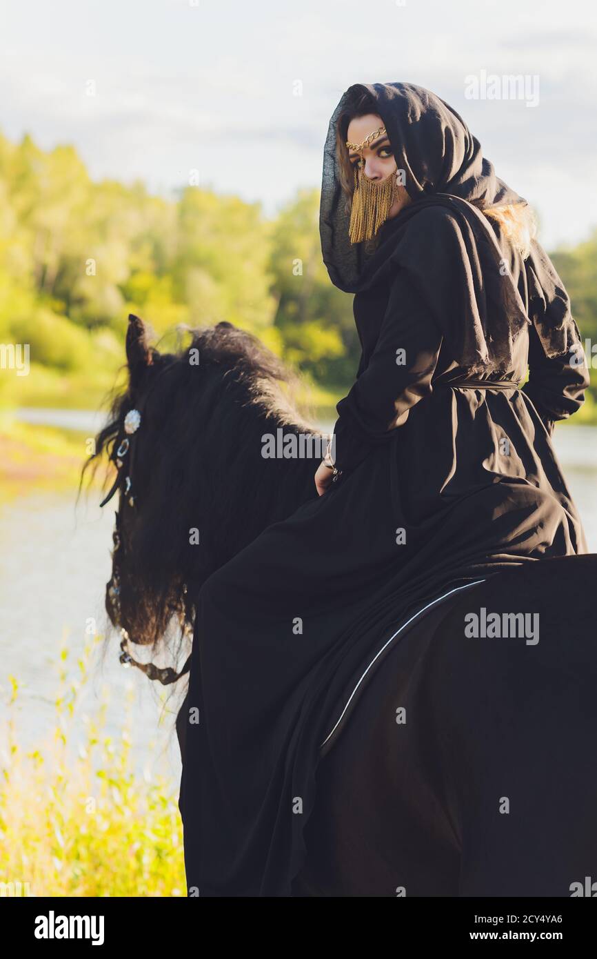Muslim woman in hijab riding a horse Stock Photo - Alamy