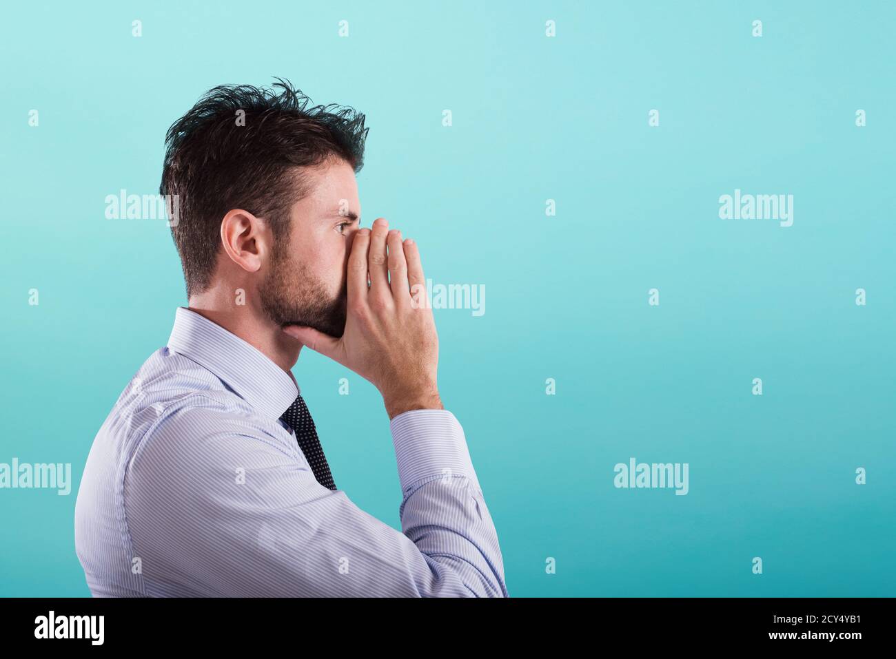 Man talks secretly covering his mouth with the hand Stock Photo - Alamy