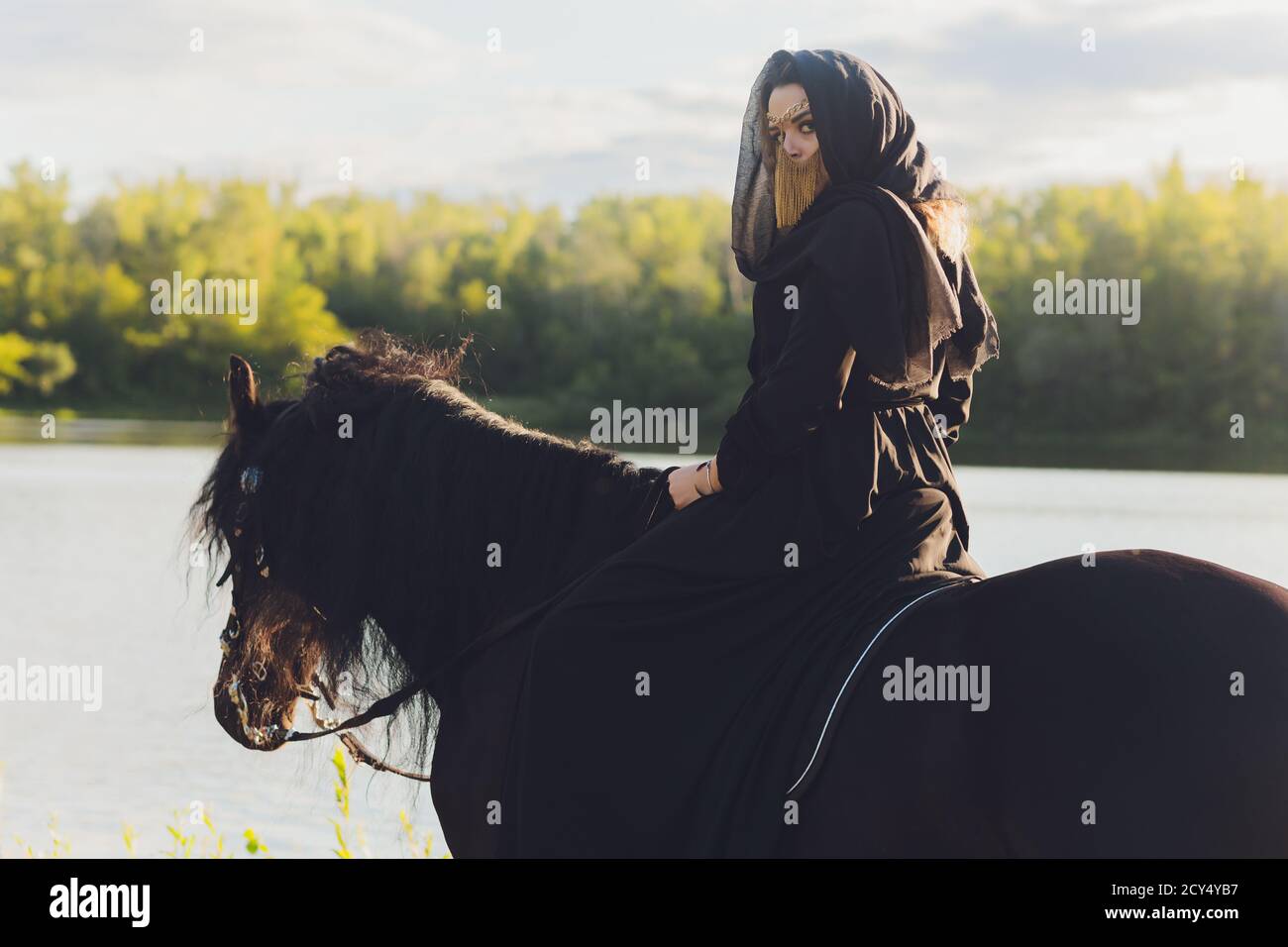 Muslim woman in hijab riding a horse Stock Photo - Alamy