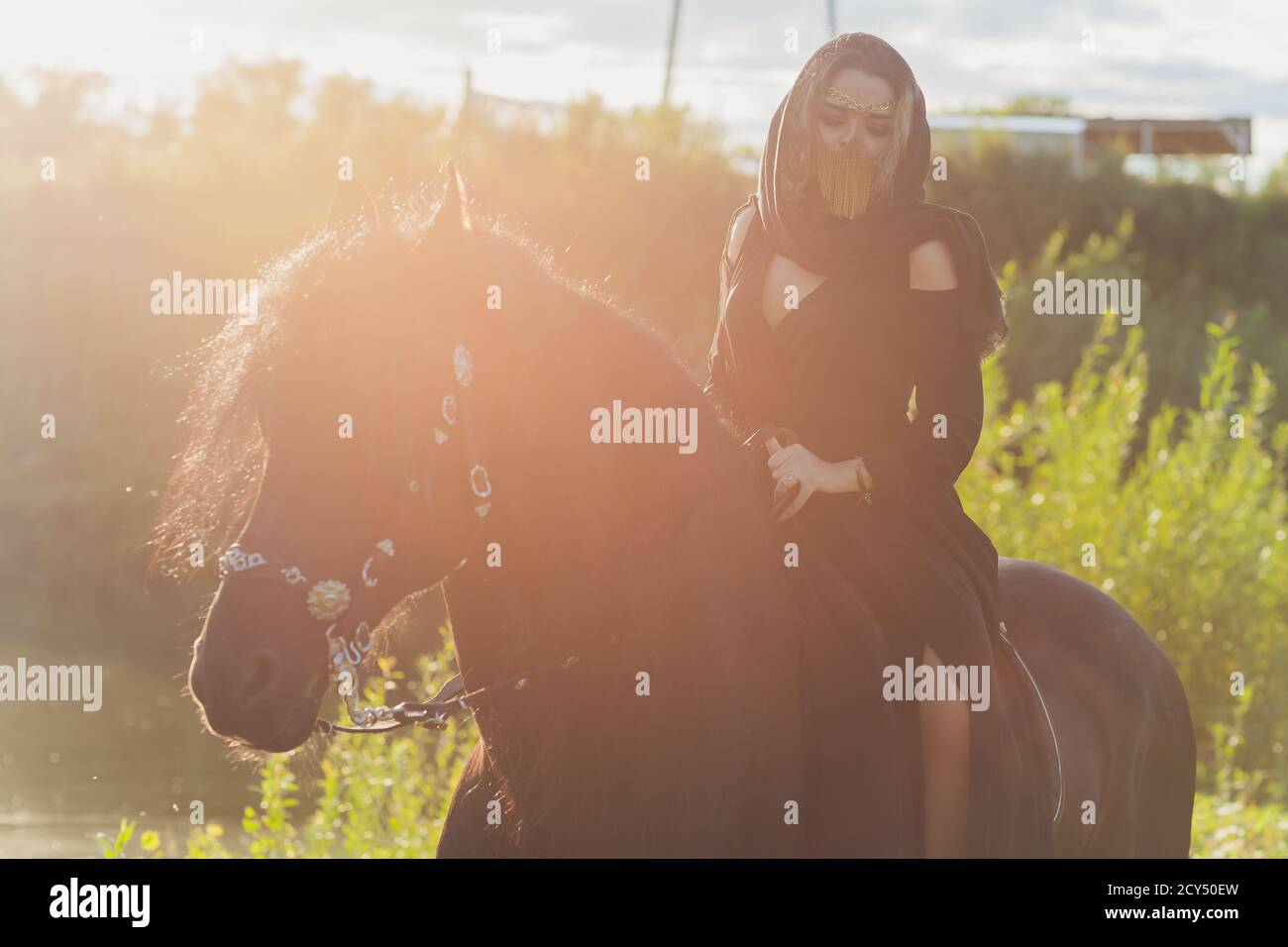 Muslim woman in hijab riding a horse Stock Photo - Alamy