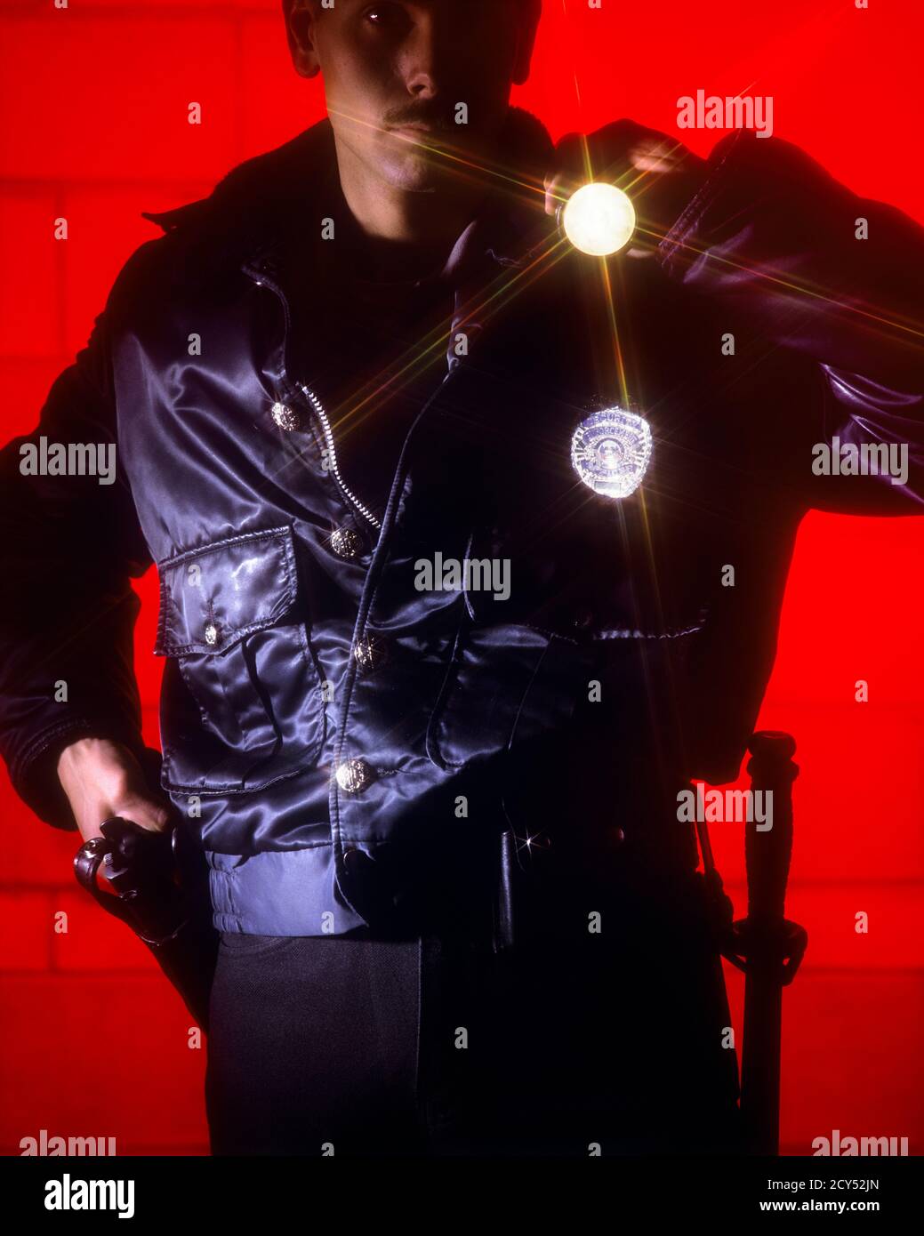 1990s POLICEMAN HAND ON GUN WITH FLASHLIGHT POINTED AT CAMERA RED ...