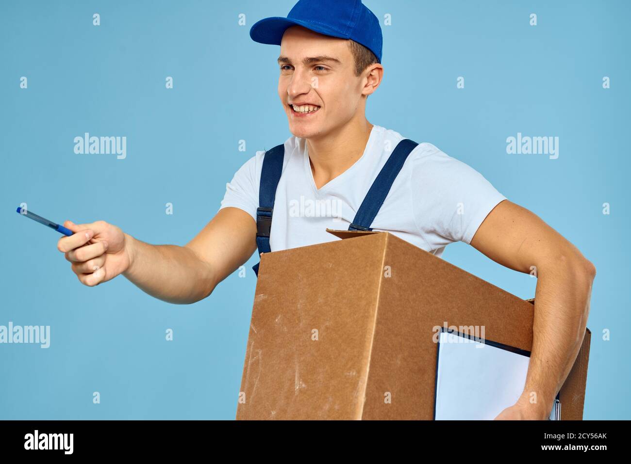 Man worker with cardboard box delivery loader lifestyle blue background ...