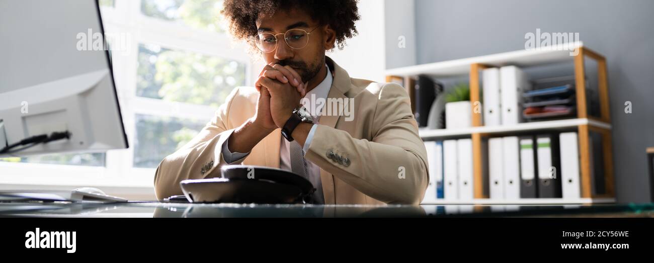 African American Waiting Landline Phone Call At Office Desk Stock Photo ...