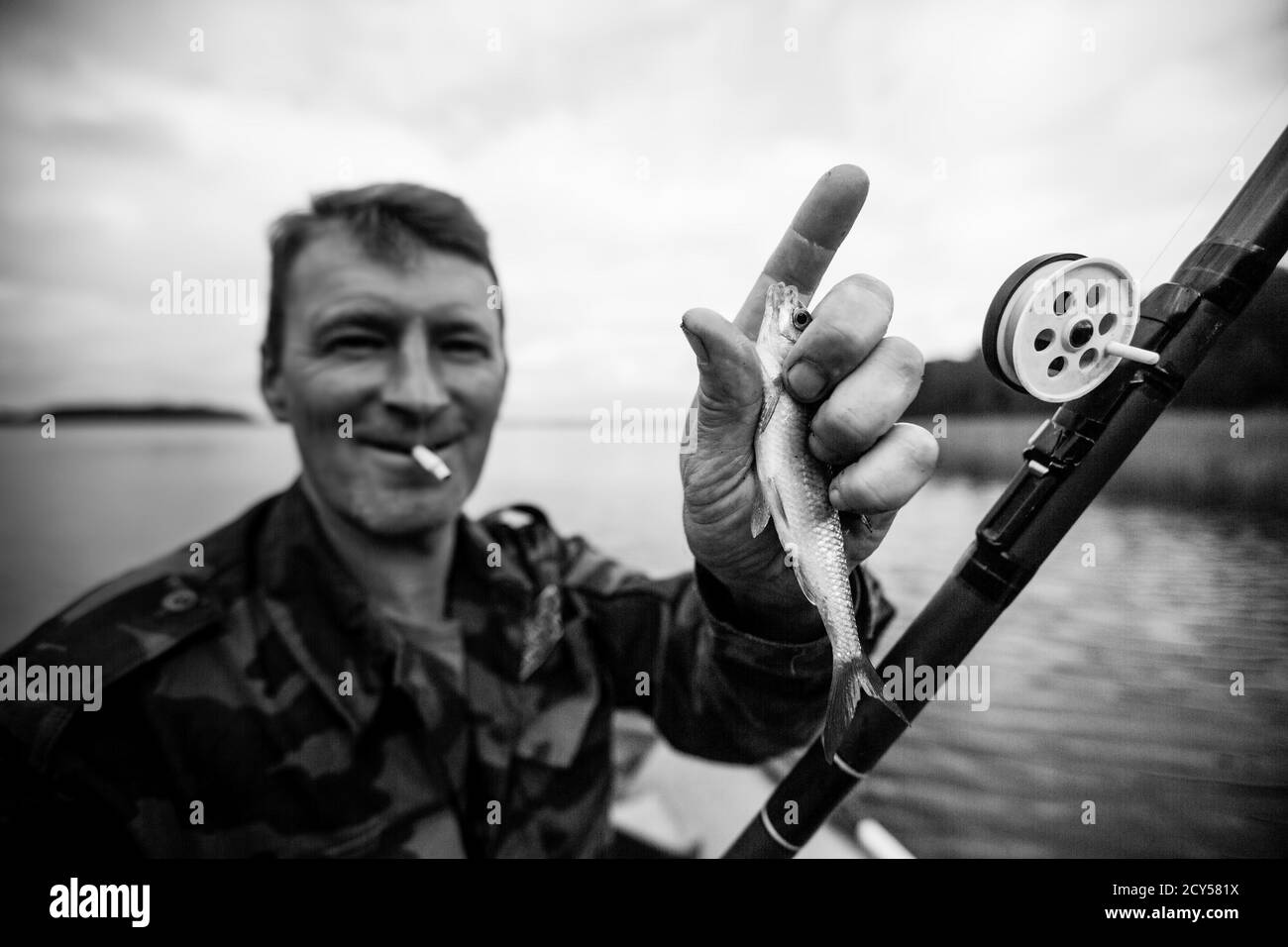 Fisherman catching fish on the lake. Black and white photography Stock ...