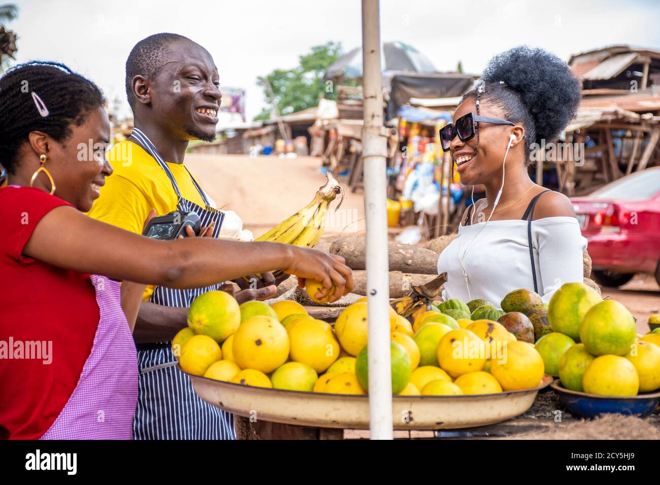 happy scene in a local african market, with cheerful traders as well as ...