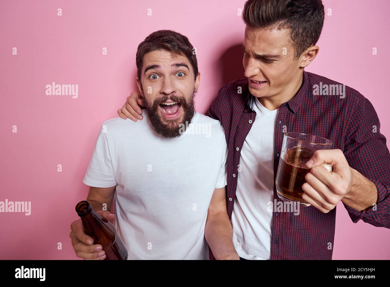 Two men drink beer friendship drunk alcohol lifestyle pink background ...