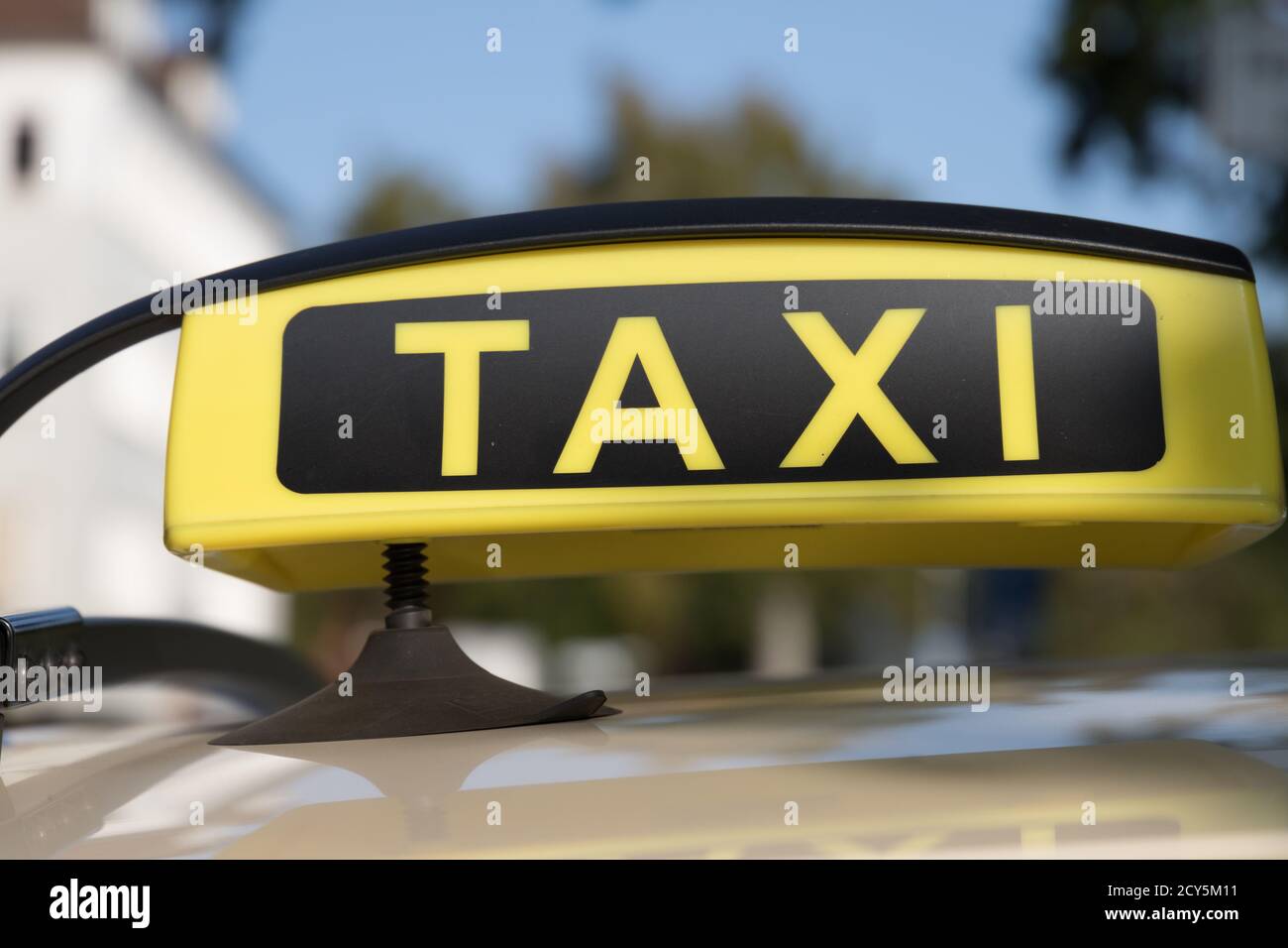Back and yellow colored taxi sign on the roof of a taxi car in Germany ...