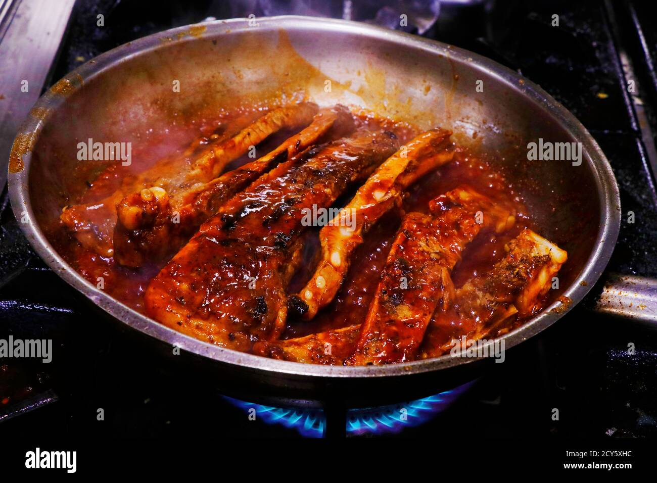sticky barbecue pork ribs in pan with hot sauce Stock Photo - Alamy