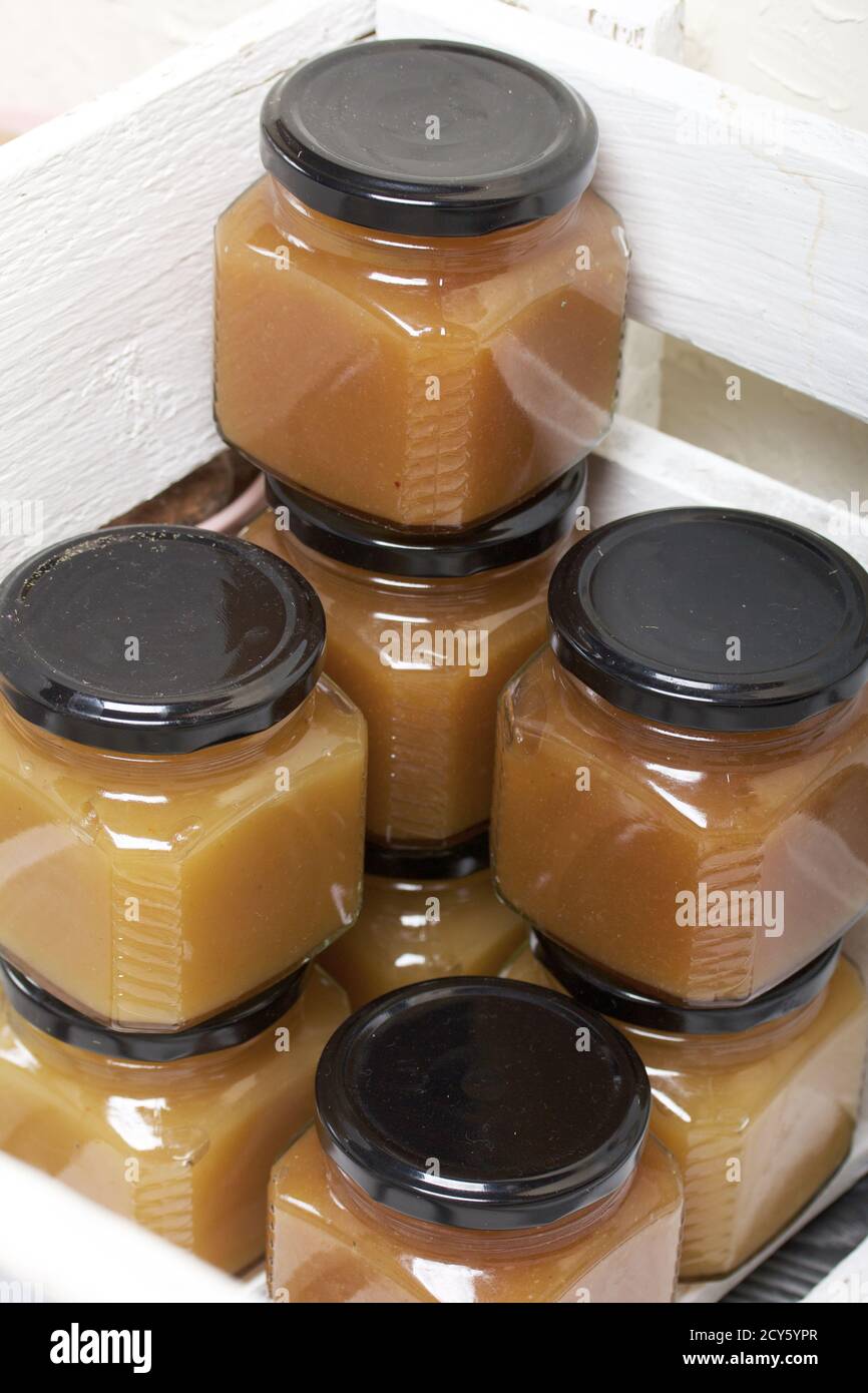 Fruit jam in jars. Stands in a wooden box painted white Stock Photo - Alamy