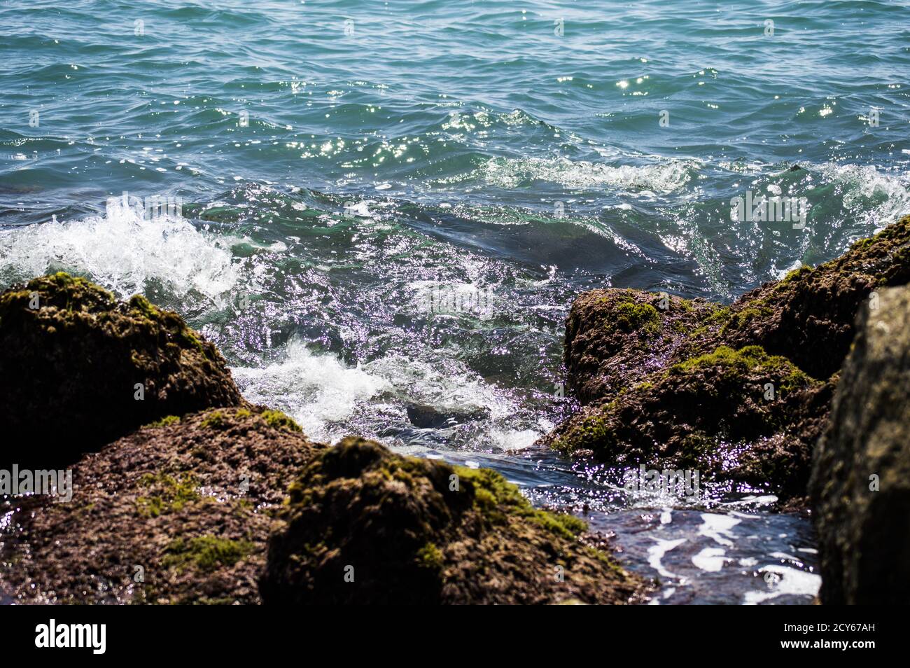Wavy sea and rocky beach Stock Photo - Alamy