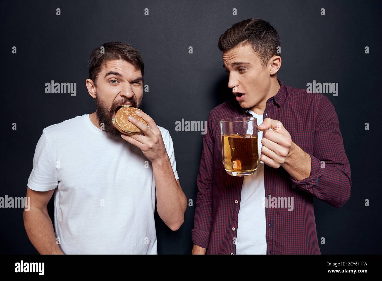 Two drunk friends drinking beer rest fun dark background Stock Photo ...