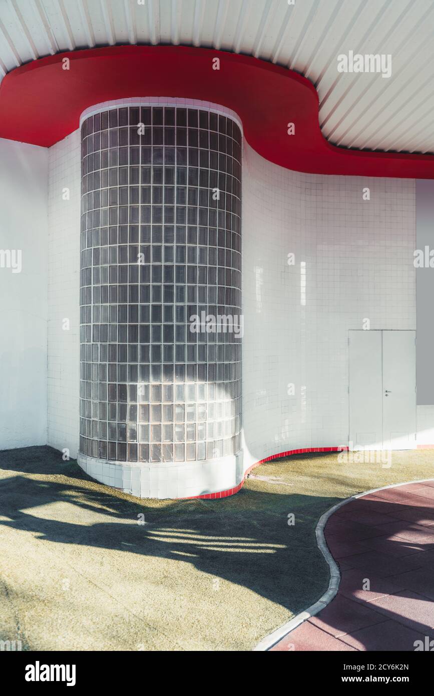 A vertical shot of a curved part of a vintage building facade with a ...