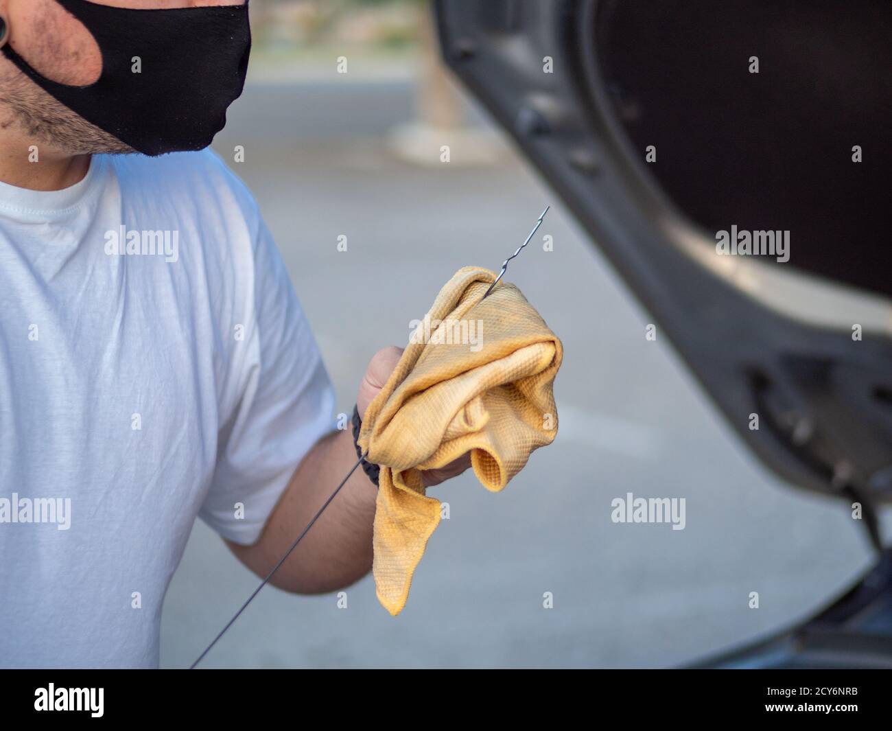 Male cleaning a wire with a mop Stock Photo - Alamy