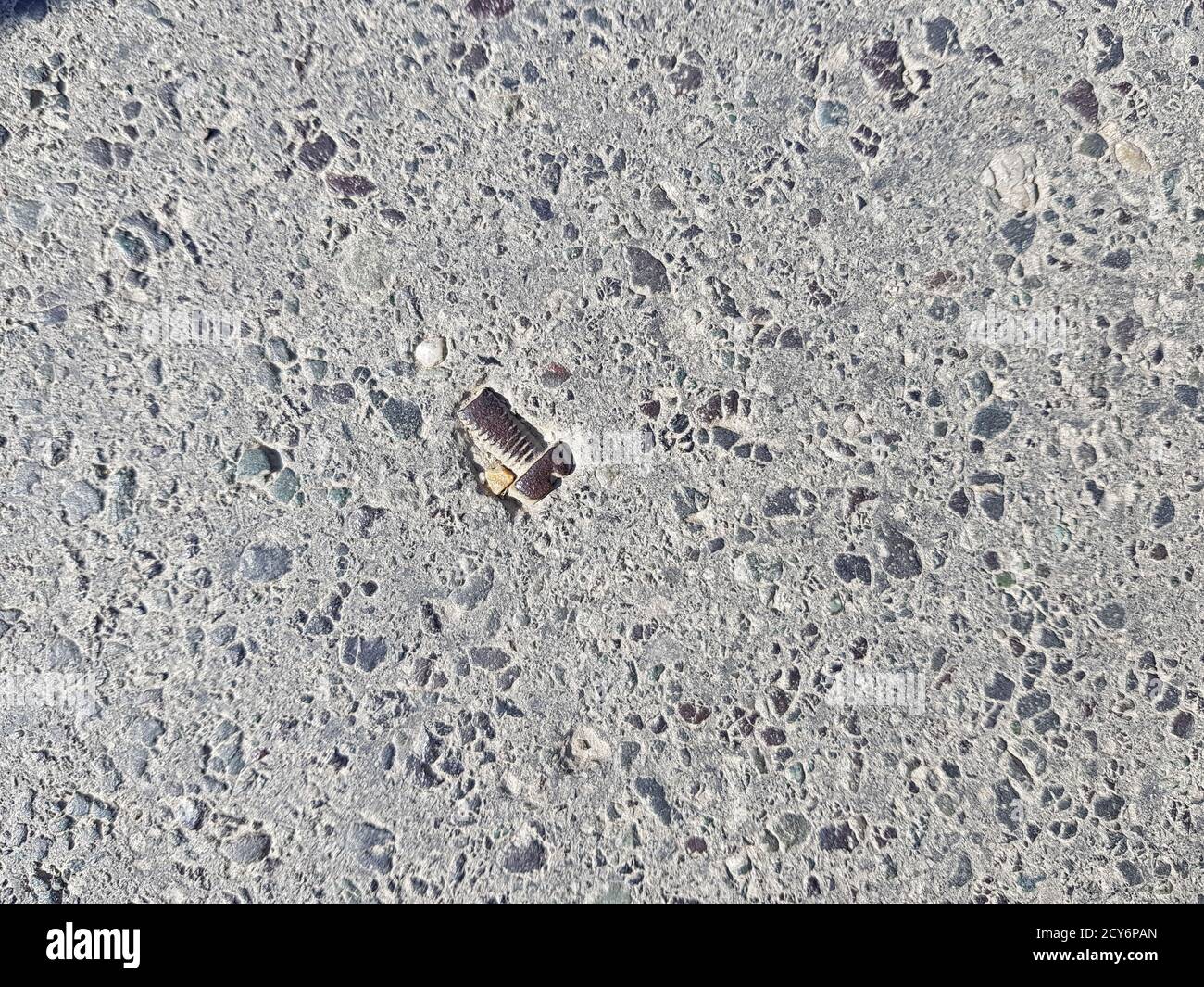 Nail dug into a stone ground Stock Photo - Alamy