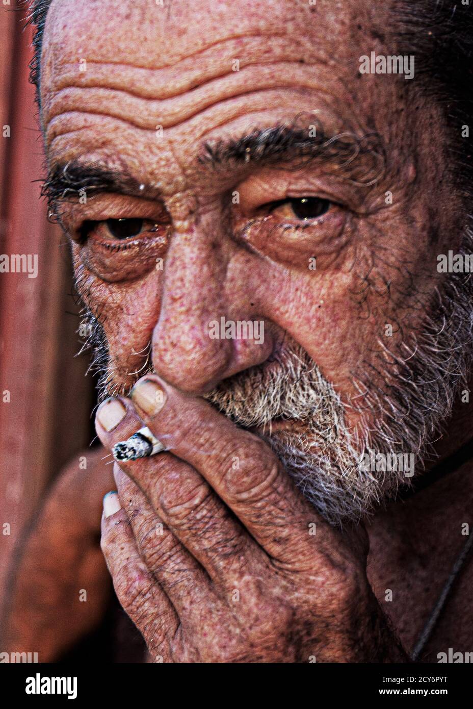 Vertical portrait of an old wrinkled male smoking a cigarette Stock ...