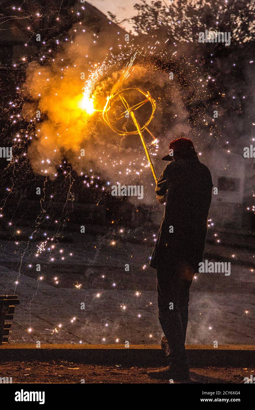 Cuenca, Ecuador - Nov 29, 2012: Man holds fireworks pinwheel at the end ...